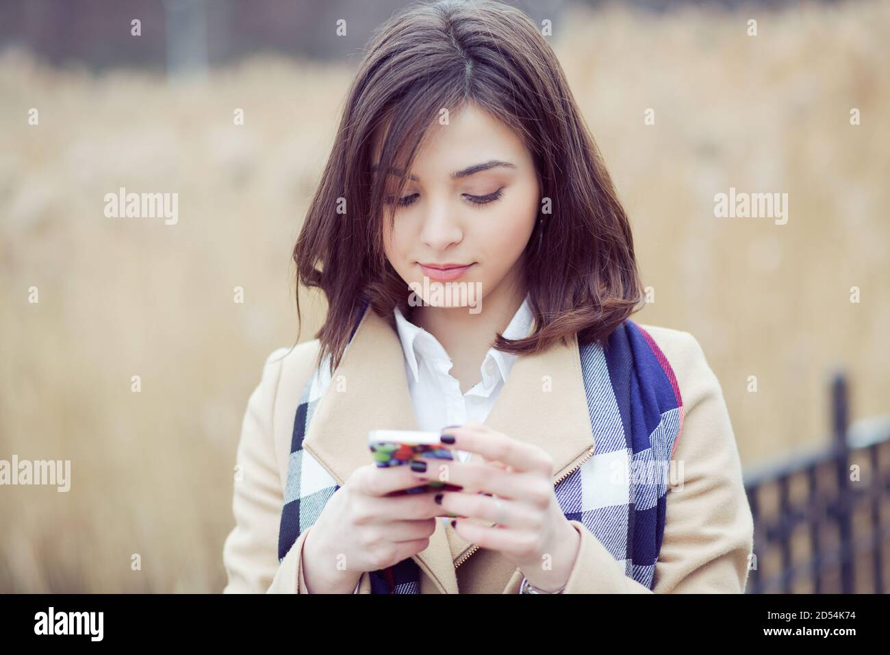 Closeup portrait serious woman talking texting on phone displeased with ...