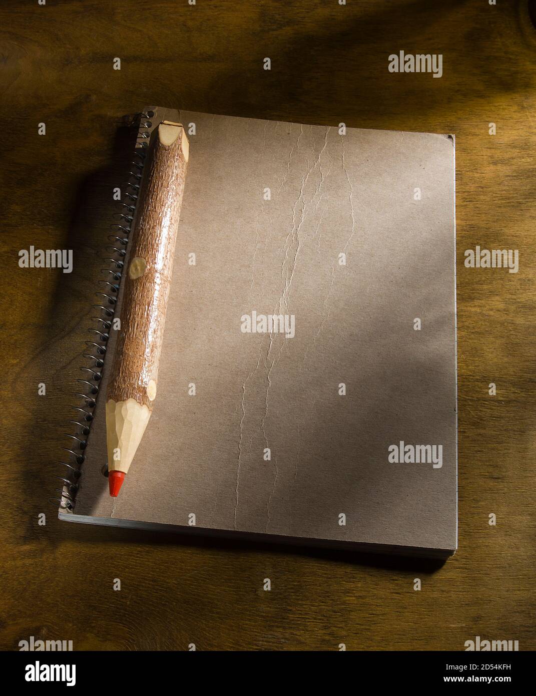 Large wooden pencil with red lead and notepad on the table Stock Photo ...