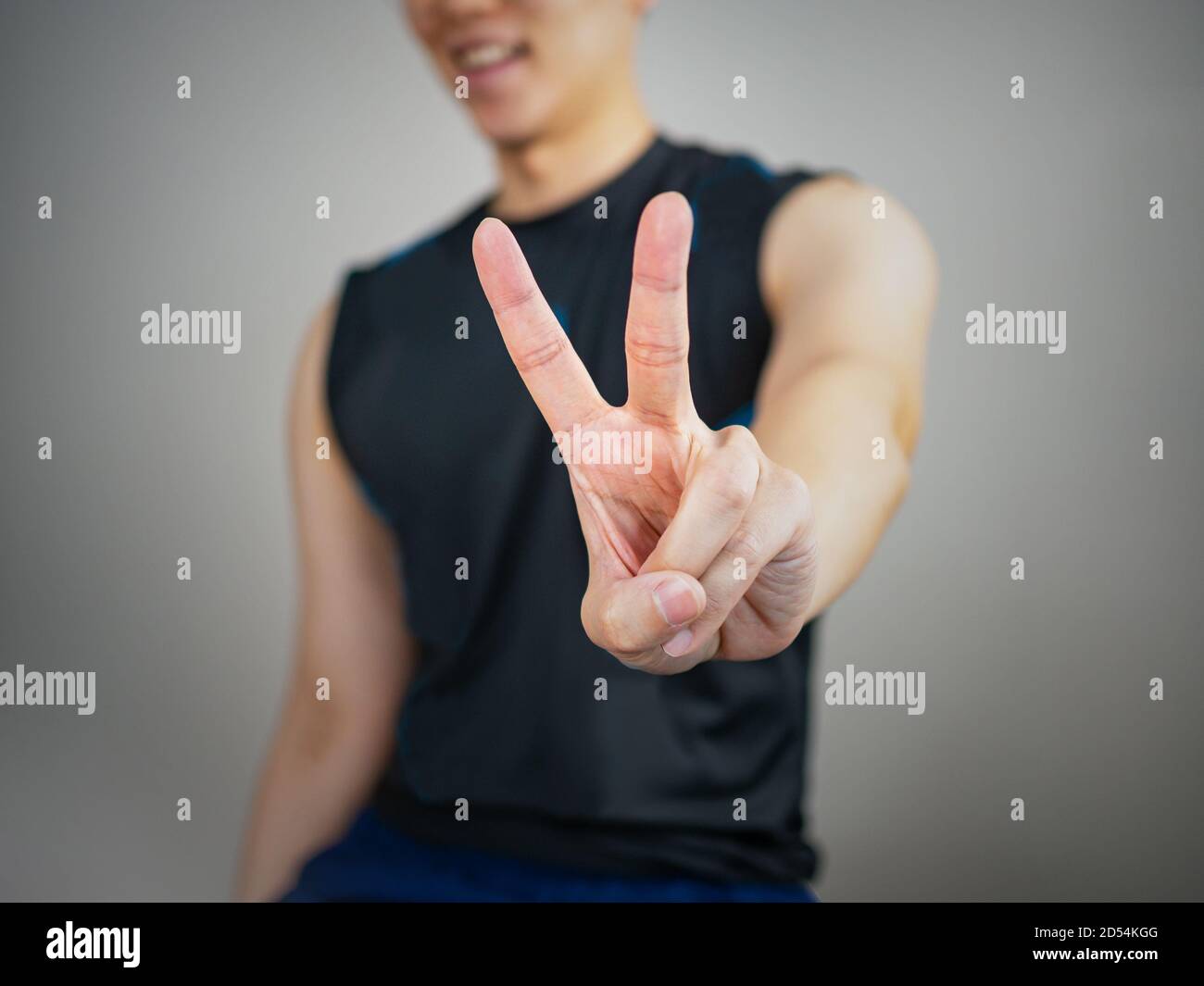 Two hand gesture by man wearing sport wear Stock Photo - Alamy