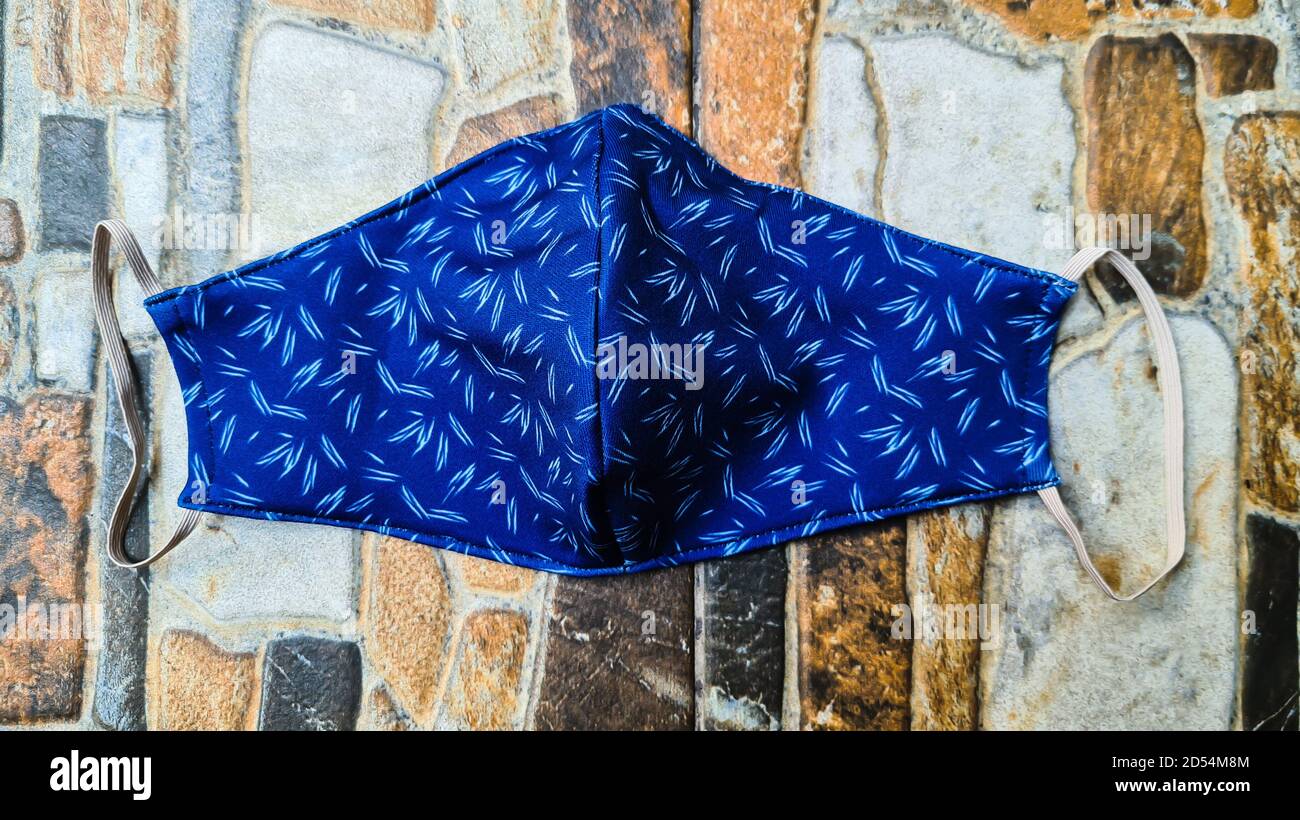 Top view of a blue face mask on the ceramic tiles Stock Photo - Alamy