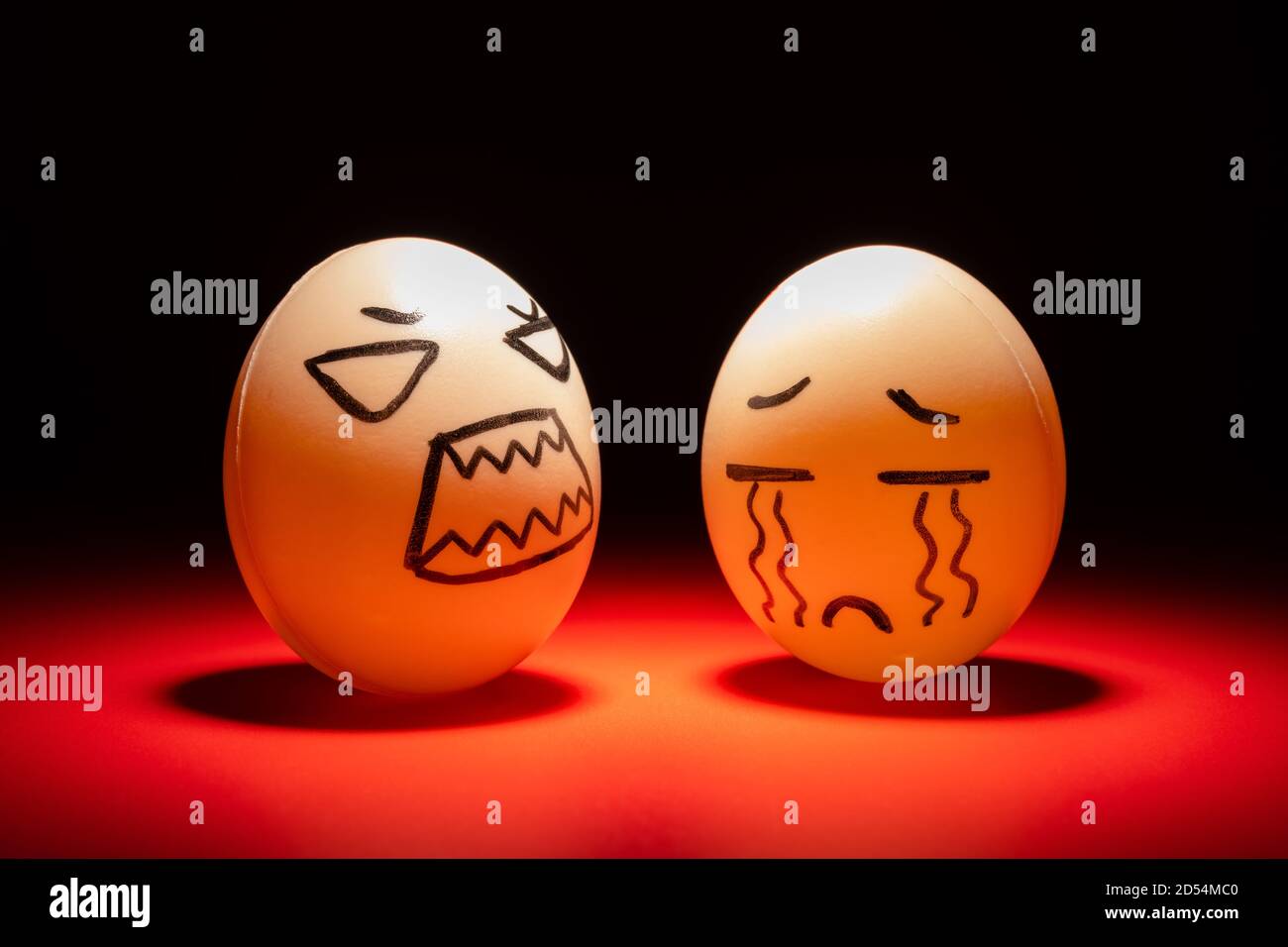 egg faces of an angry one blaming a crying one highlighted in dark ...