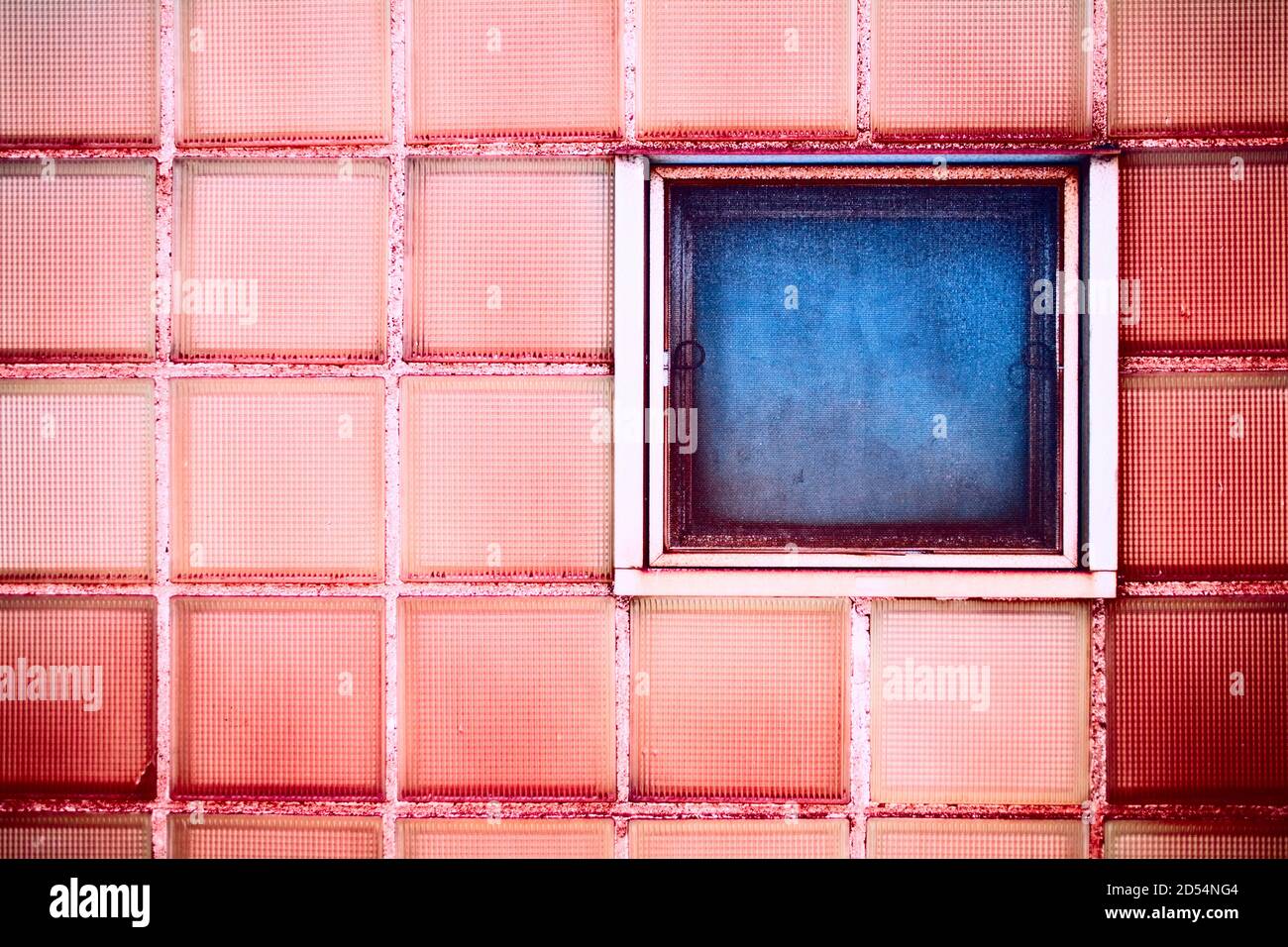 A blue square window on a wall surrounded in square red glass Stock ...