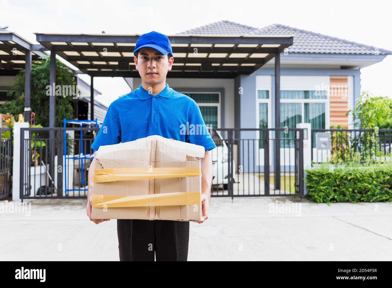 Asian young delivery man in blue uniform he emotional falling courier ...