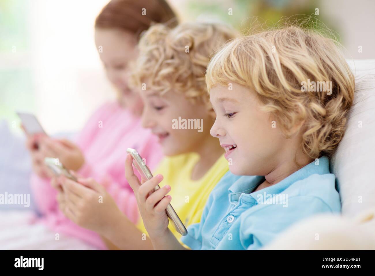 Kids with mobile phone. Child with tablet computer watching movie or ...