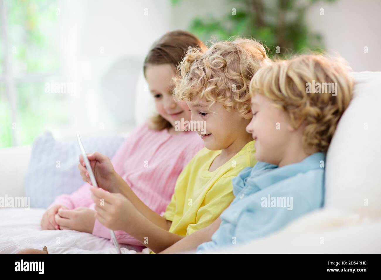 Kids with mobile phone. Child with tablet computer watching movie or ...