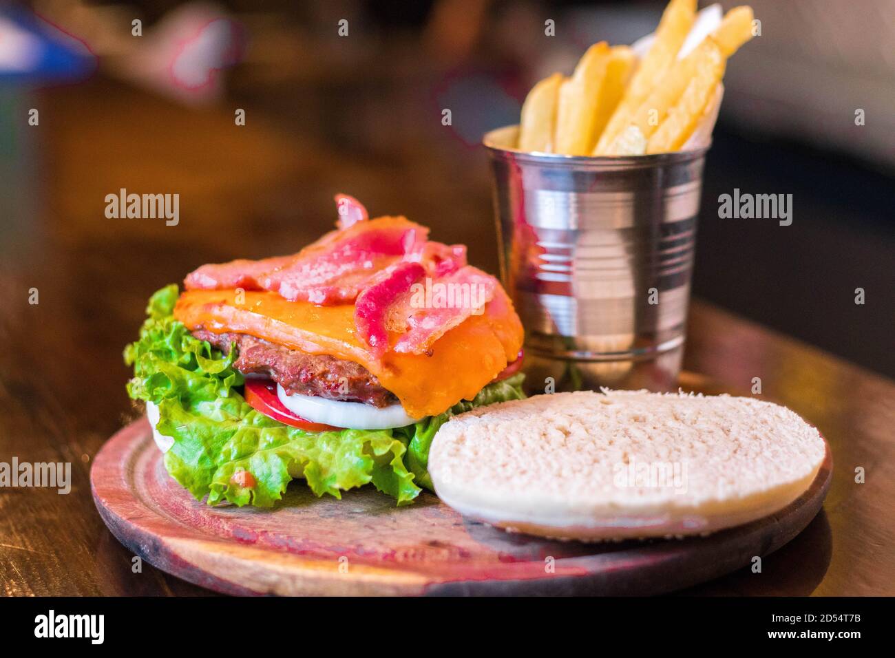 Open hamburger with fries in a restaurant Stock Photo - Alamy