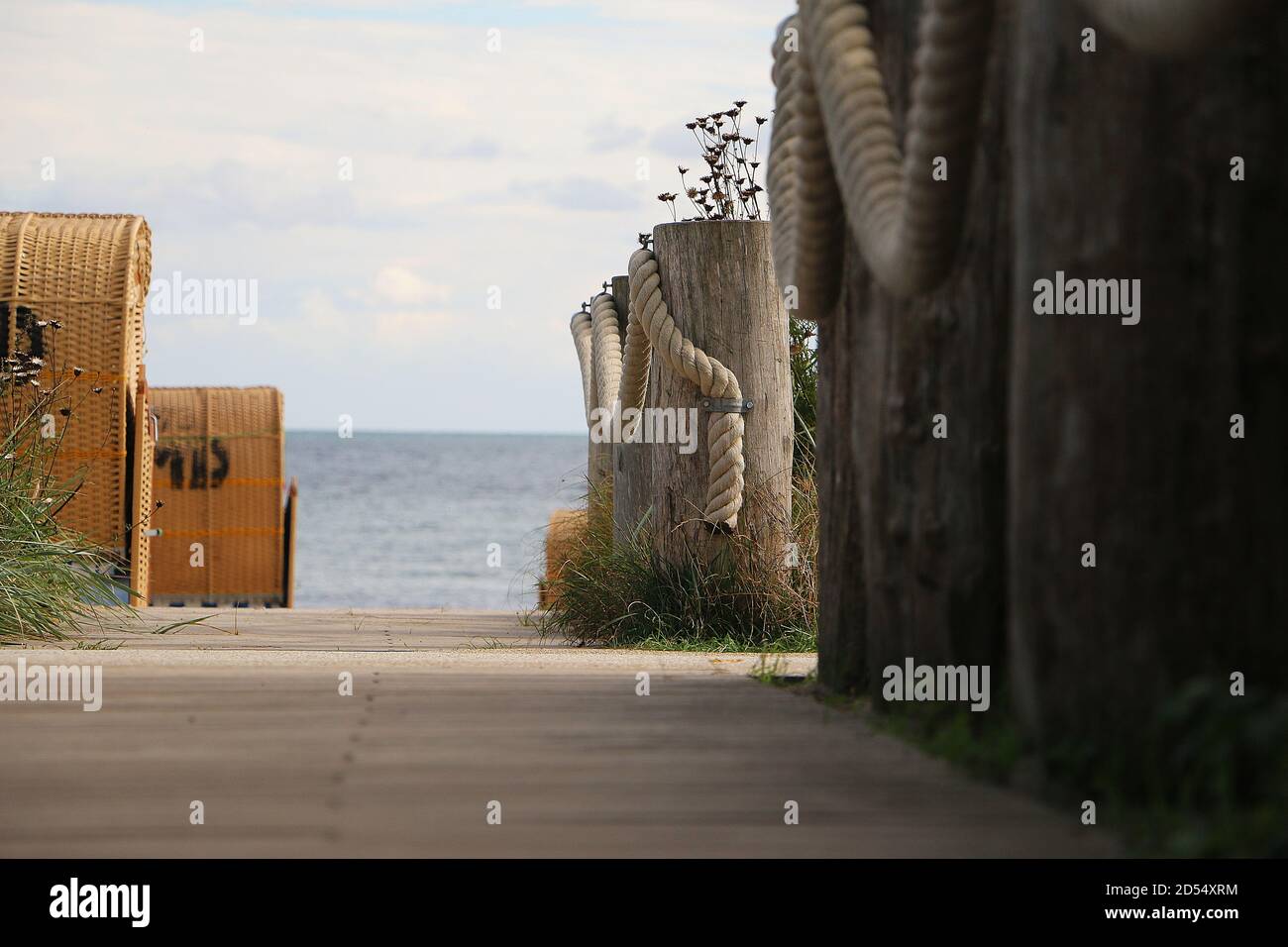 Beautiful view to the beach between beach chairs and planks with a ...