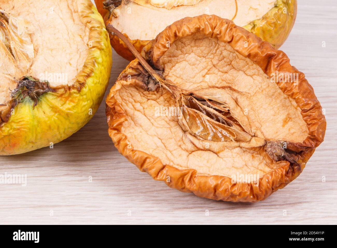 Old wrinkled moldy apple on board, unhealthy and disgusting eating ...