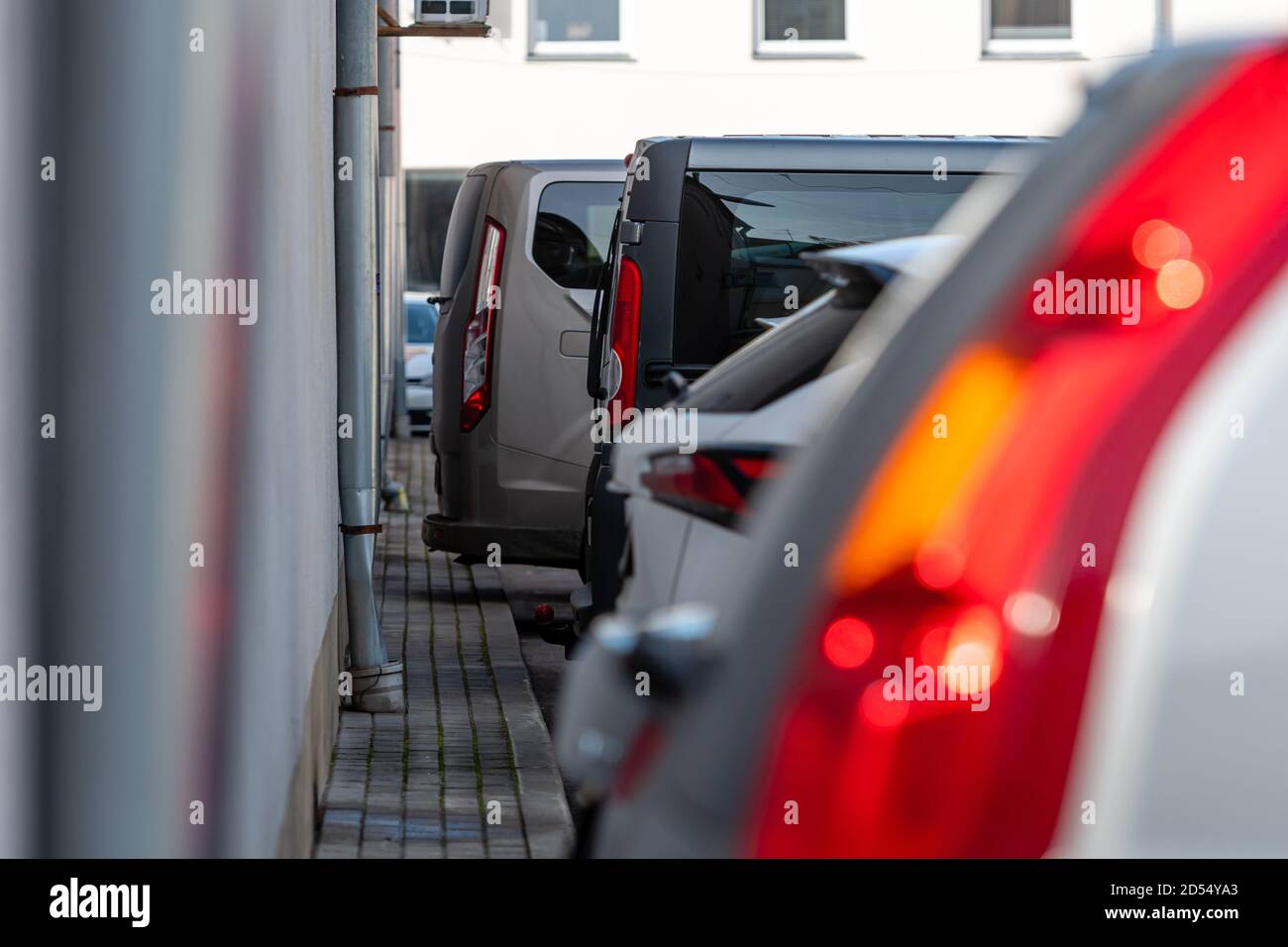 a row of cars in the parking lot outside the office building, close-up ...