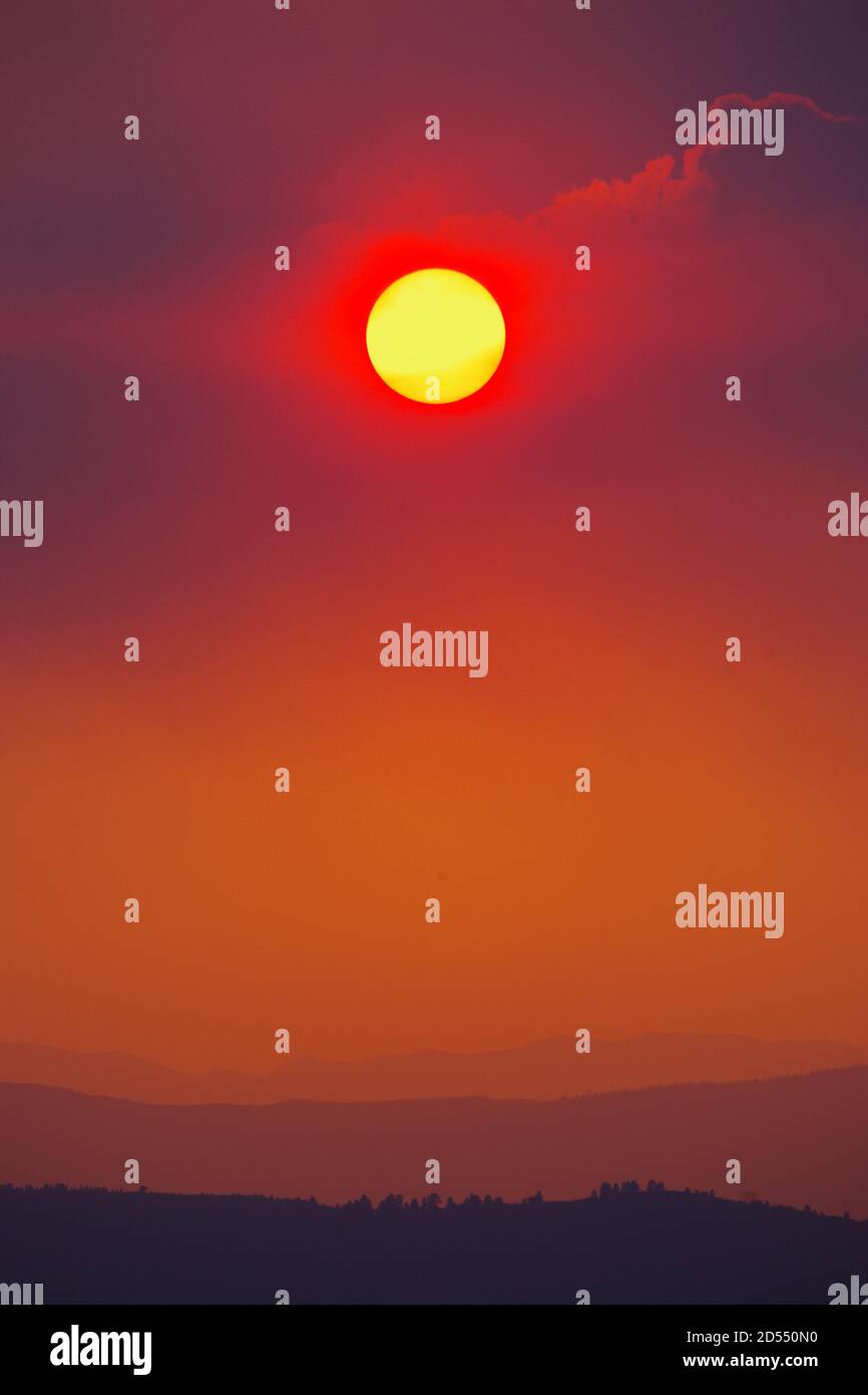 sunset scene with smoke in the air Stock Photo - Alamy