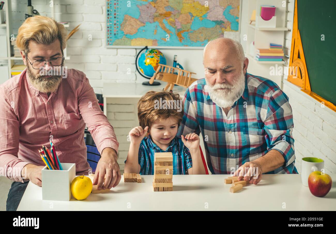 Jenga game at home. Happy three generations of men playing Jenga in ...
