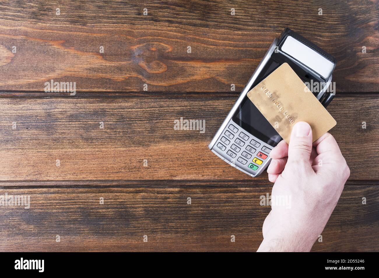 Close up of man hand holding bank card near payment terminal, Paypass ...