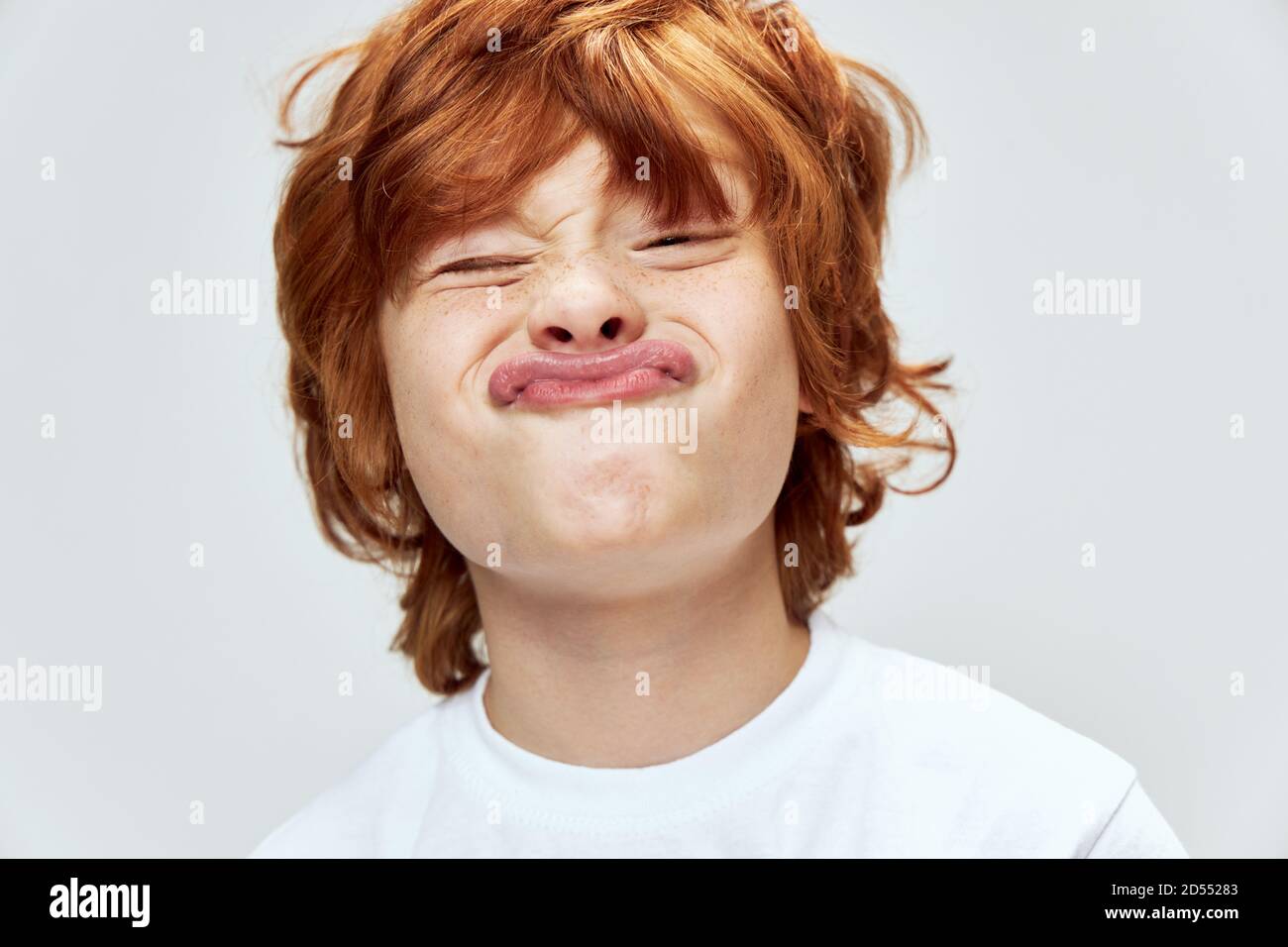 grimacing redhead boy face close up fun childhood Stock Photo - Alamy