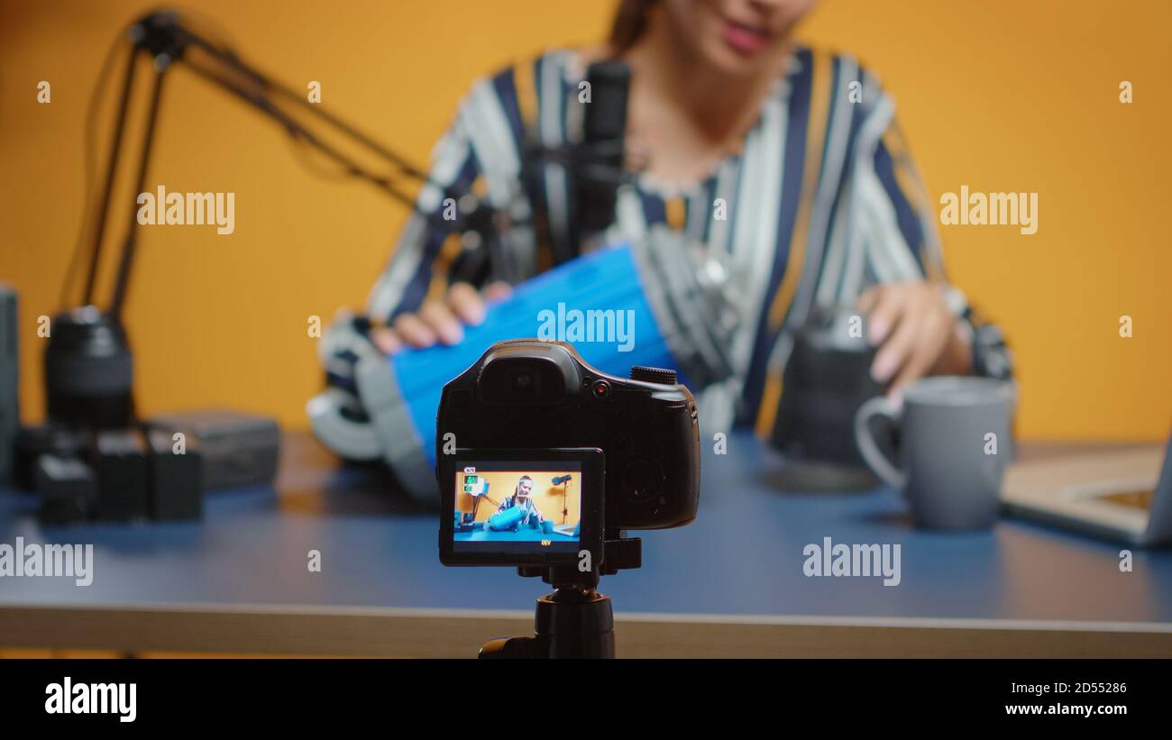 Close up of influencer recording on camera video light review. Social ...