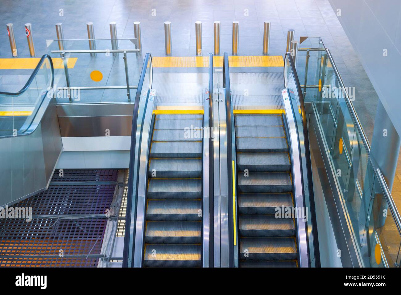 Two escalator stairs up and down to different floors of the building ...