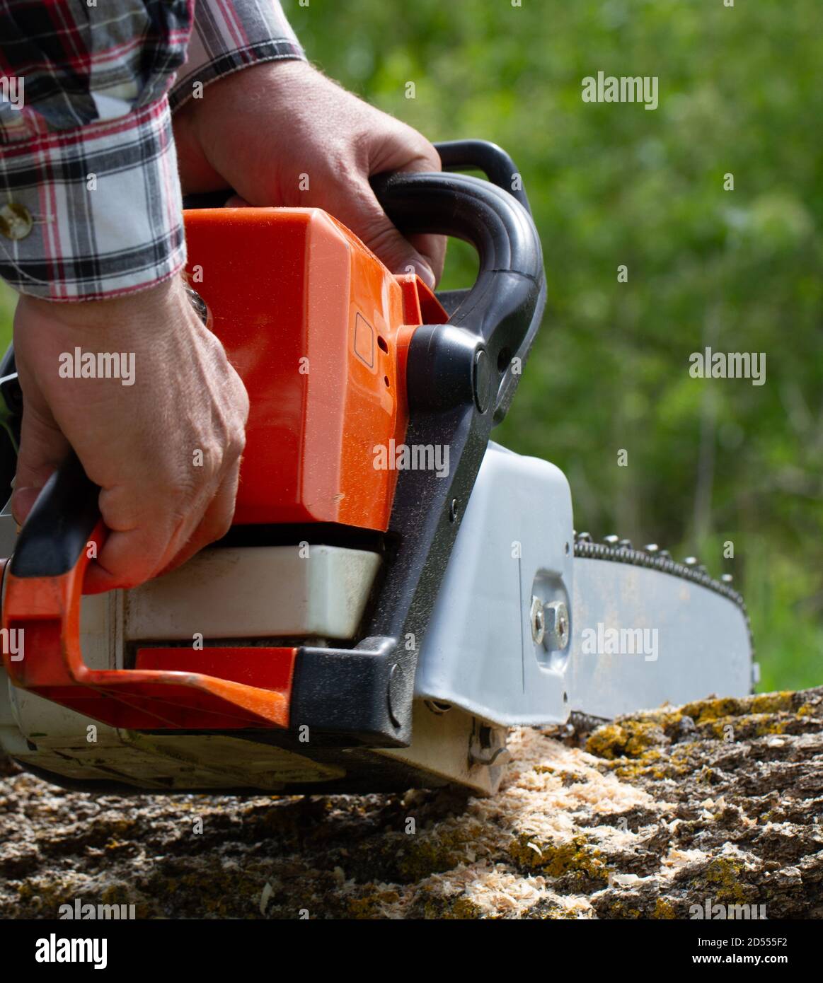 Man working by professional chain saw Stock Photo - Alamy