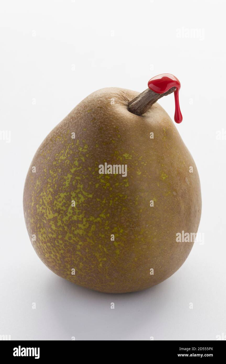 Green pear with red sealing wax on stalk Stock Photo - Alamy