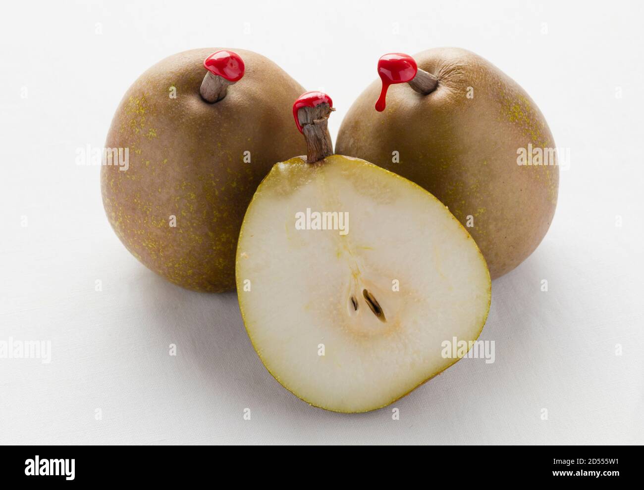 Green pears with red sealing wax on stalk Stock Photo - Alamy