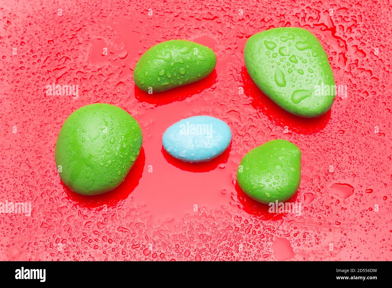 Color stones on a green background; various colors, yellow, black ...