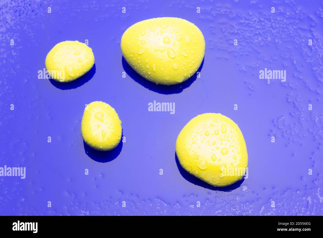 Color stones on a green background; various colors, yellow, black ...