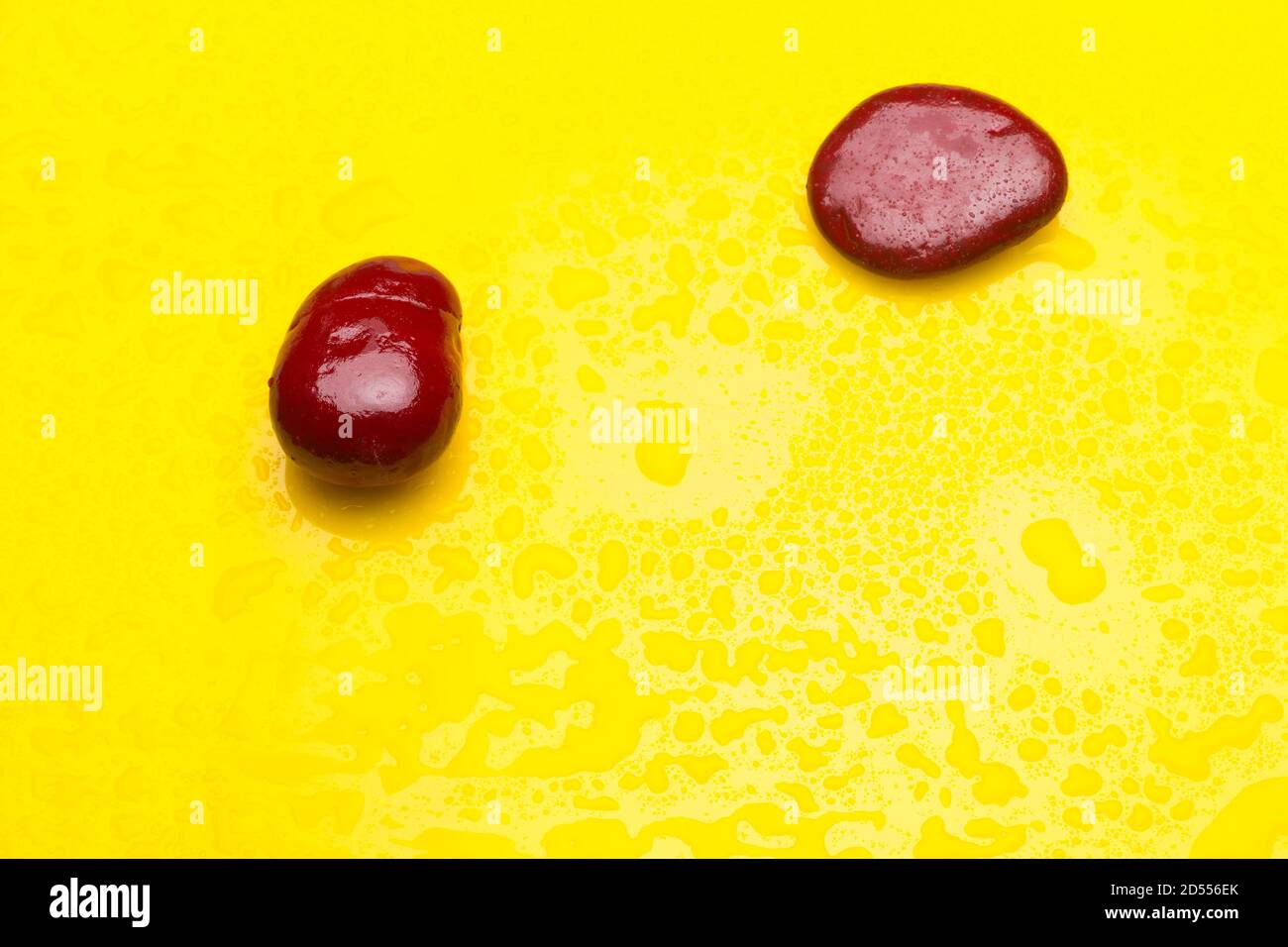 Color stones on a green background; various colors, yellow, black ...
