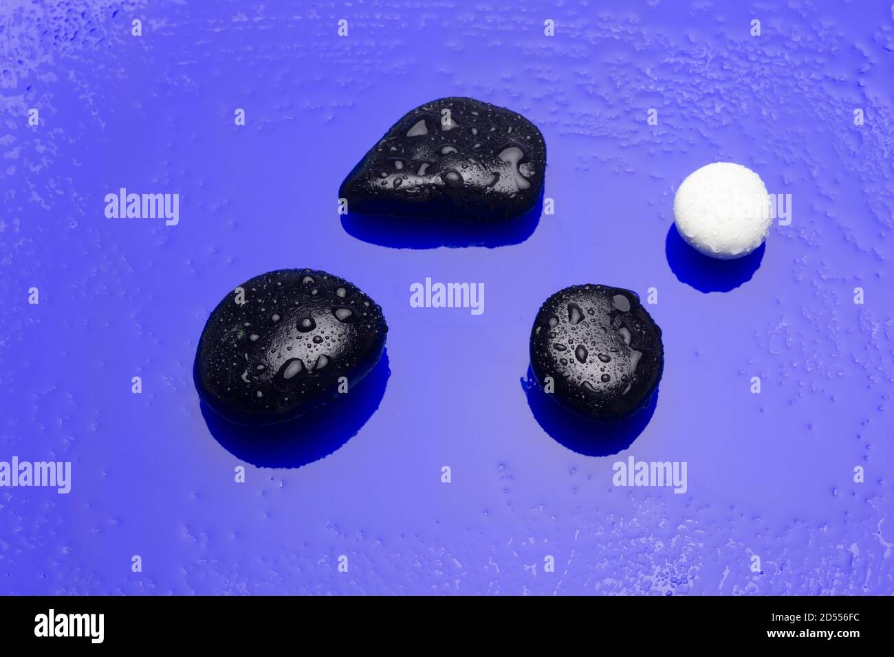 Color stones on a green background; various colors, yellow, black ...