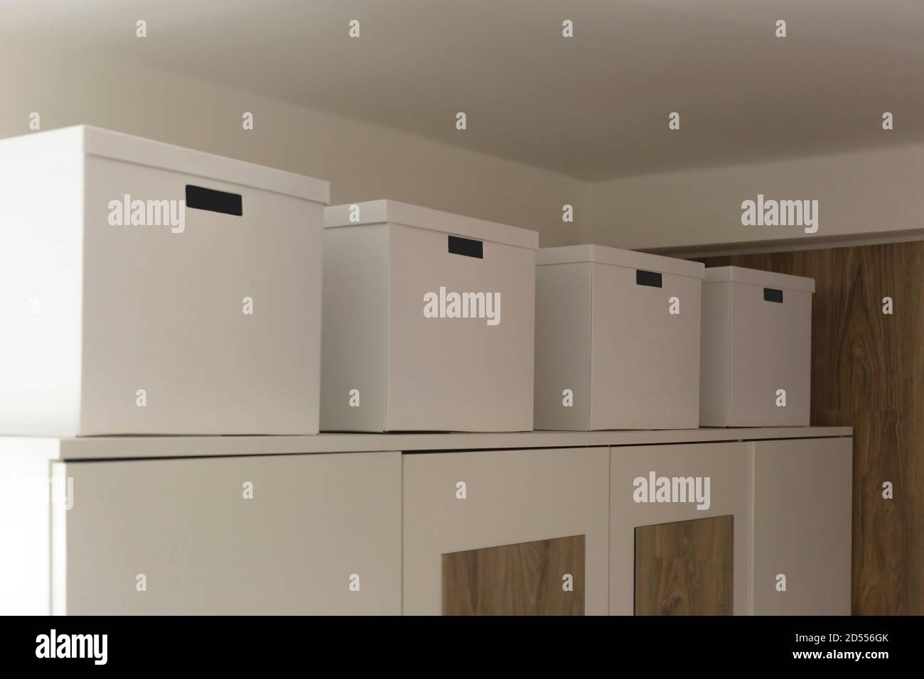 White cardboard boxes as a storage element in the interior Stock Photo ...