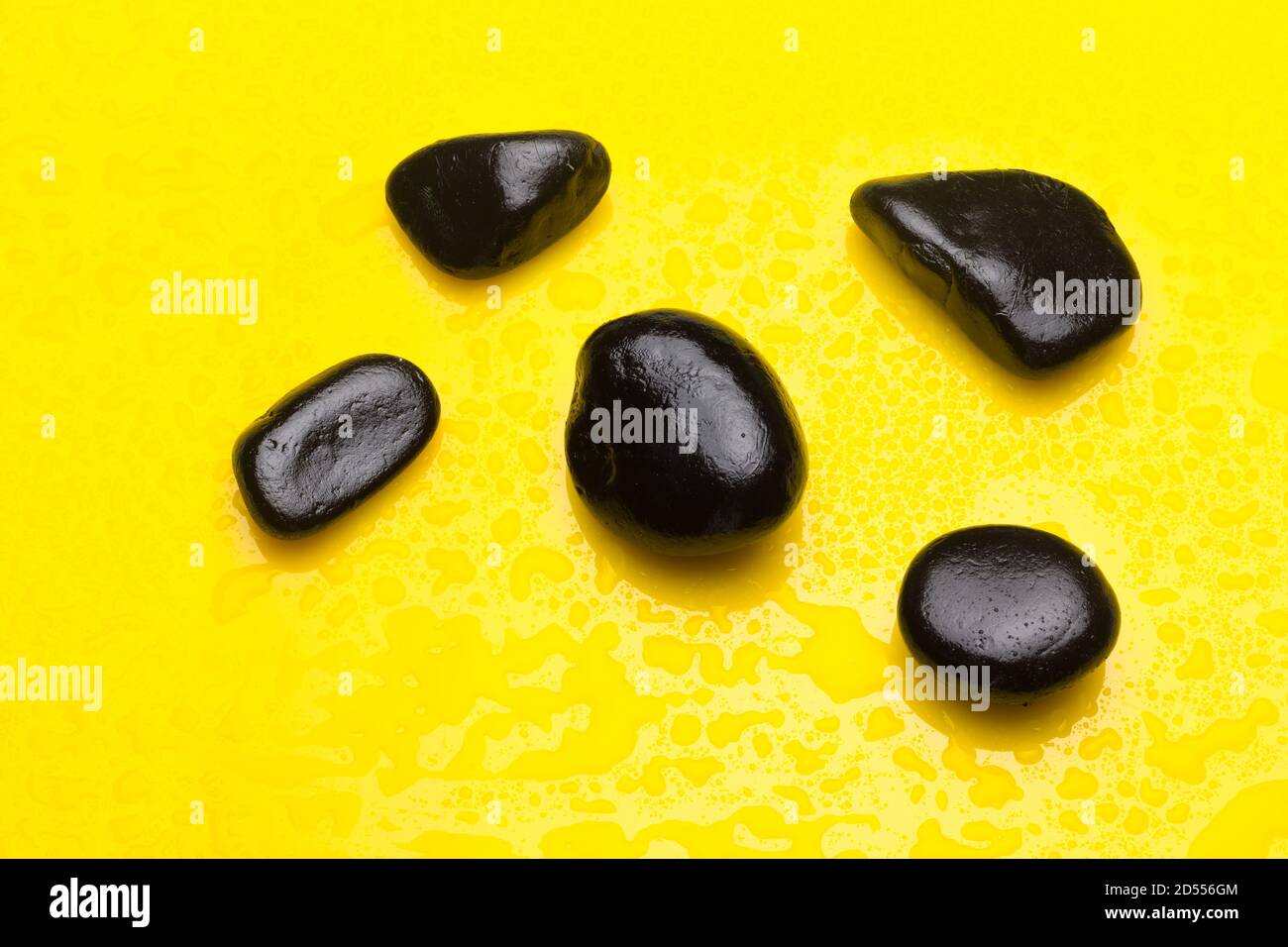 Color stones on a green background; various colors, yellow, black ...