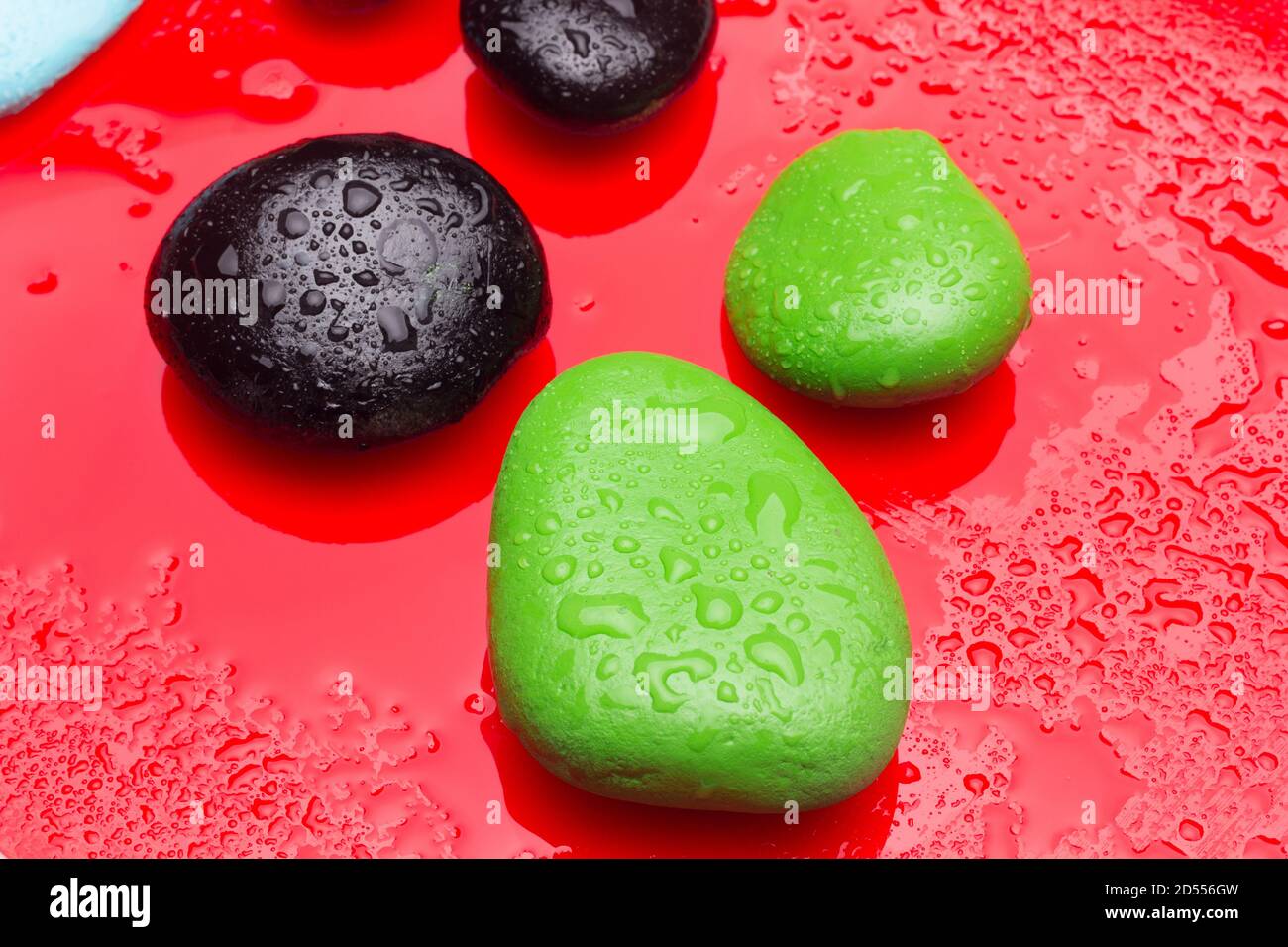 Color stones on a green background; various colors, yellow, black ...