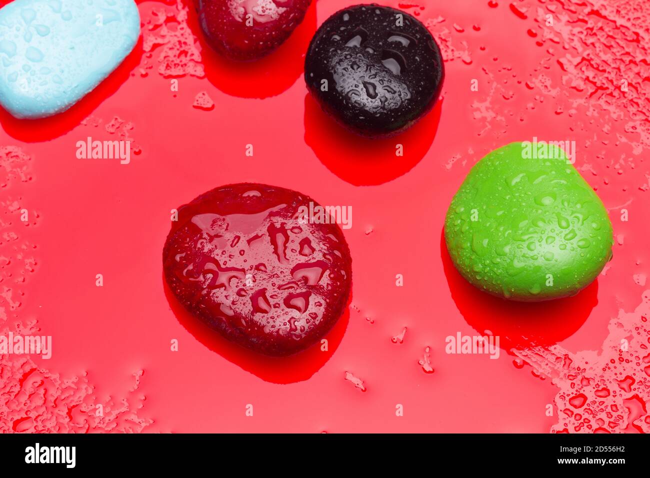Color stones on a green background; various colors, yellow, black ...