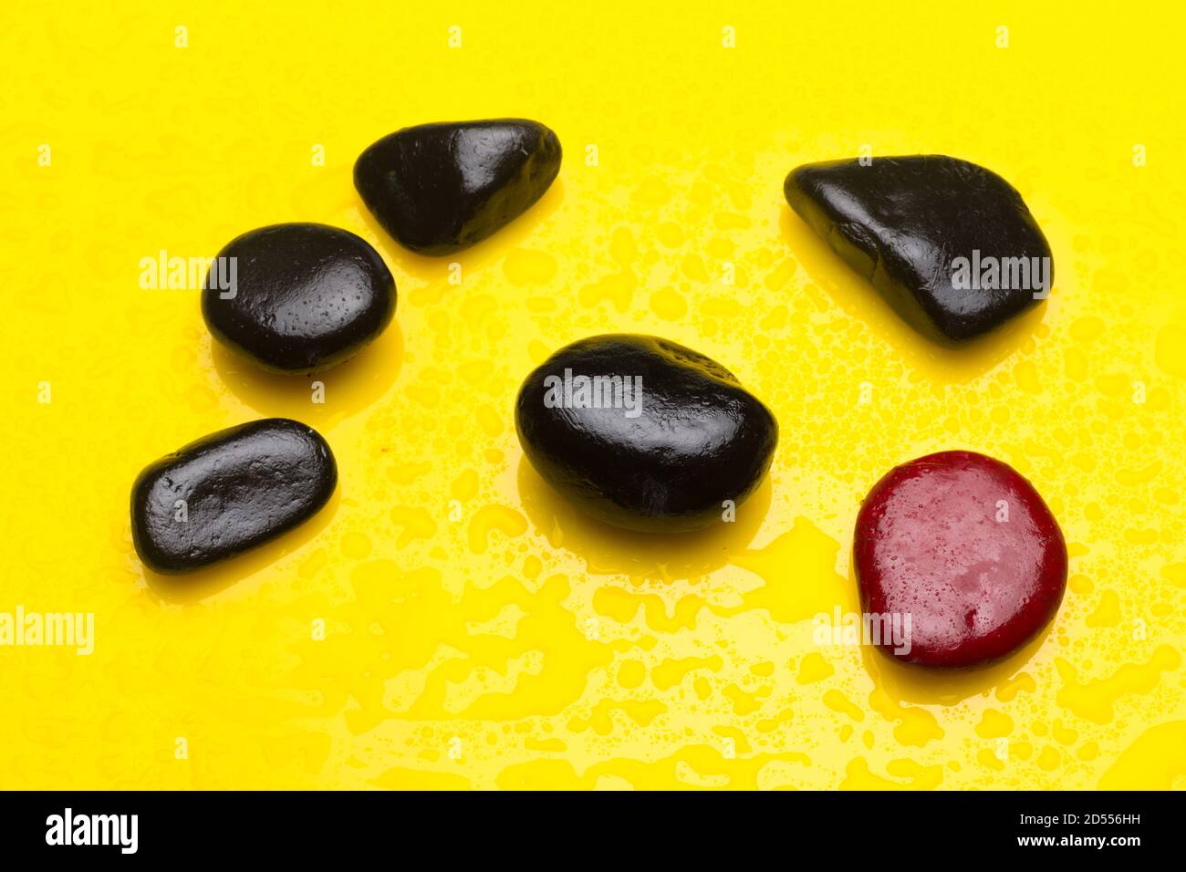 Color stones on a green background; various colors, yellow, black ...