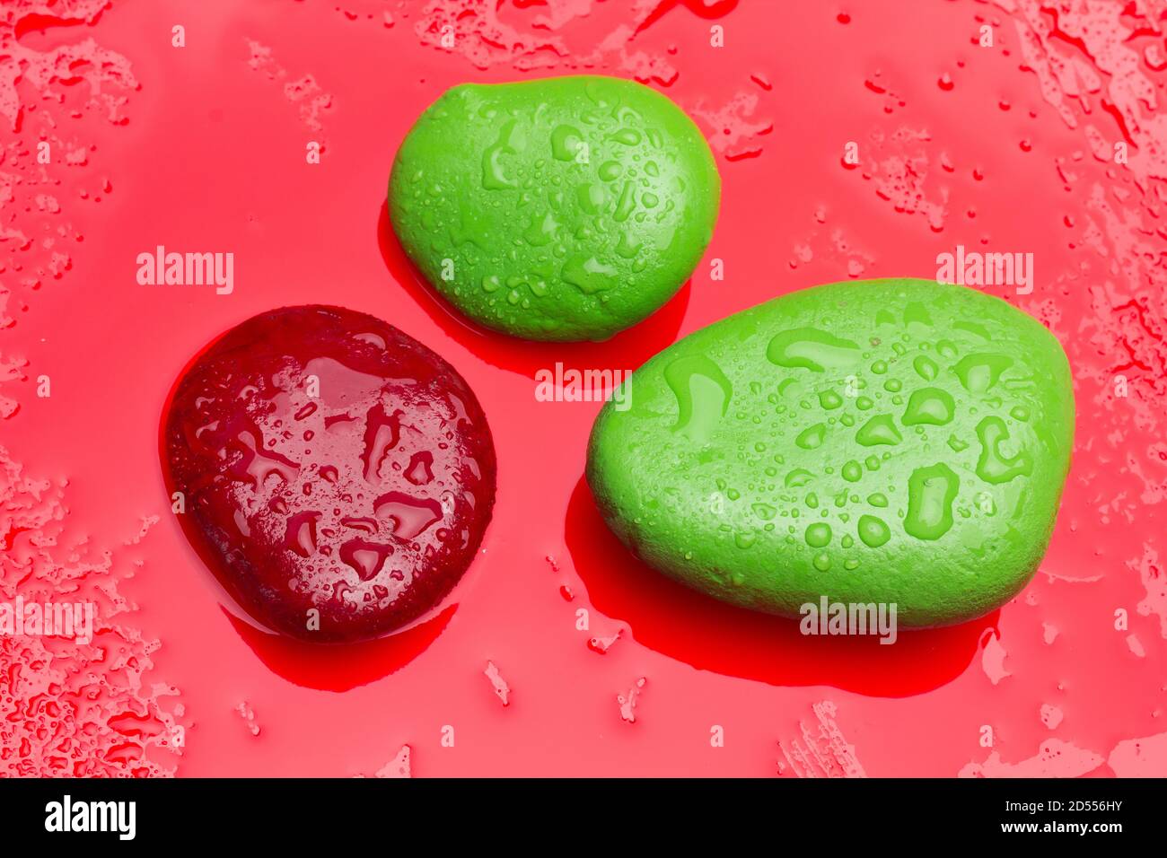 Color stones on a green background; various colors, yellow, black ...