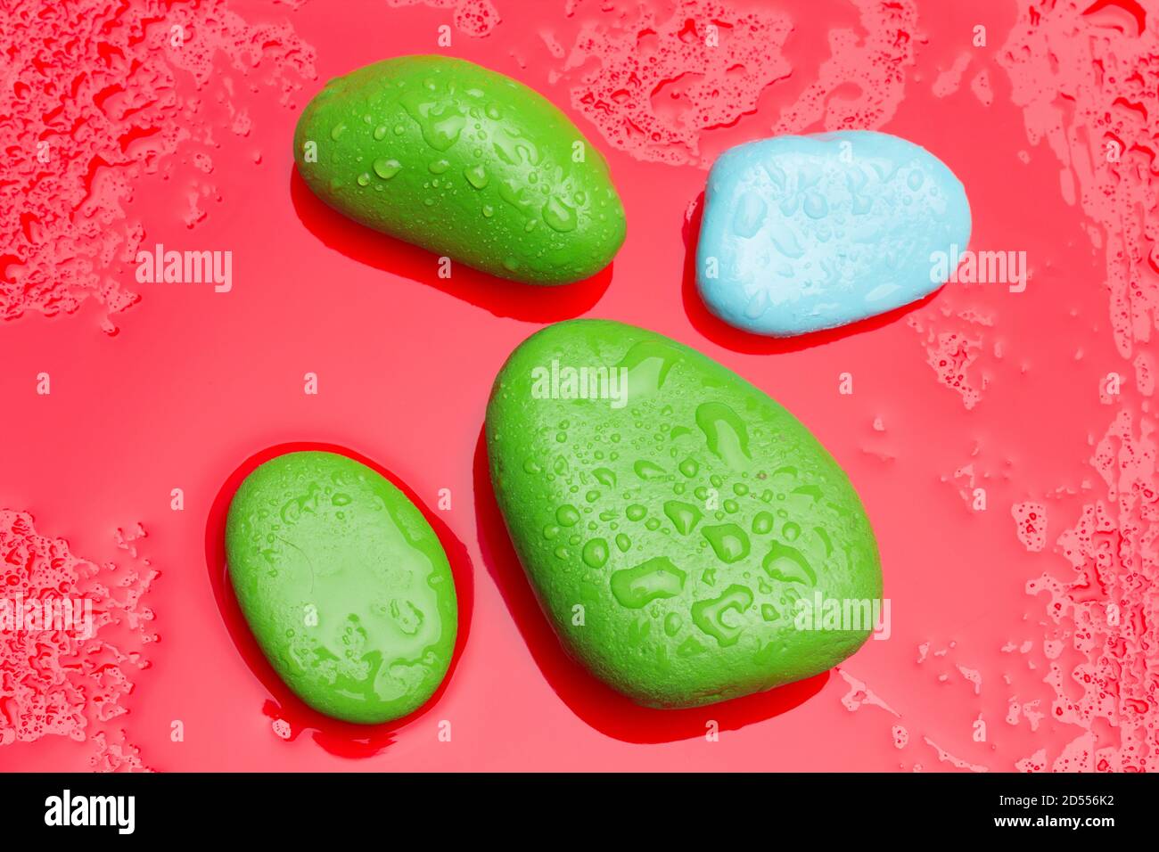 Color stones on a green background; various colors, yellow, black ...