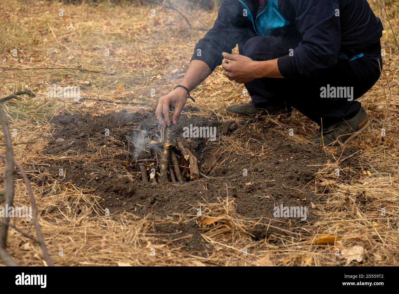 Lighting a campfire with stick hi-res stock photography and images - Alamy