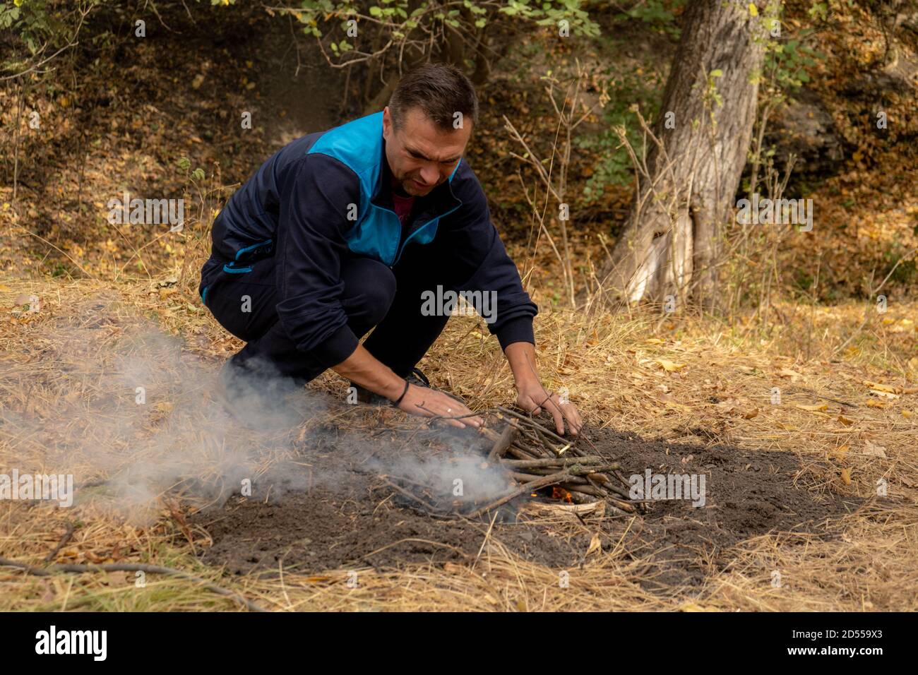 Lighting a campfire with stick hi-res stock photography and images - Alamy