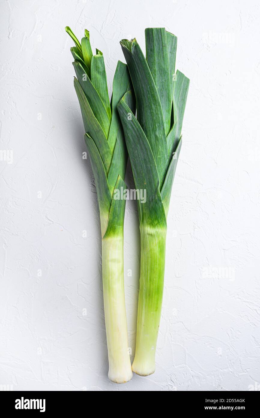 Organic Leek onion Stalks on white background, top view with space for ...