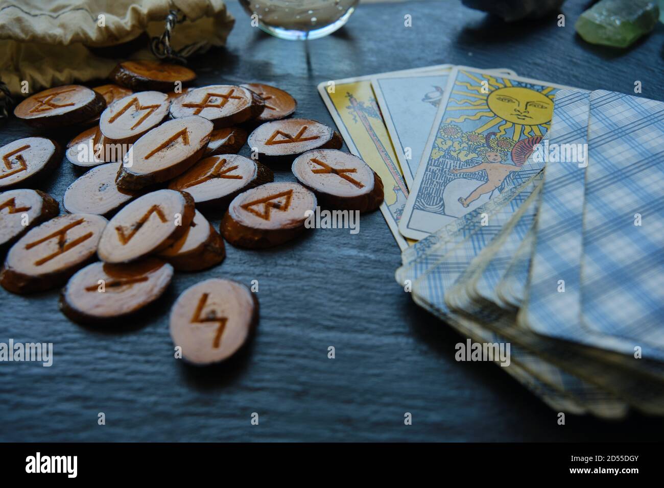 wooden runes from the Tarot card on the table Stock Photo - Alamy