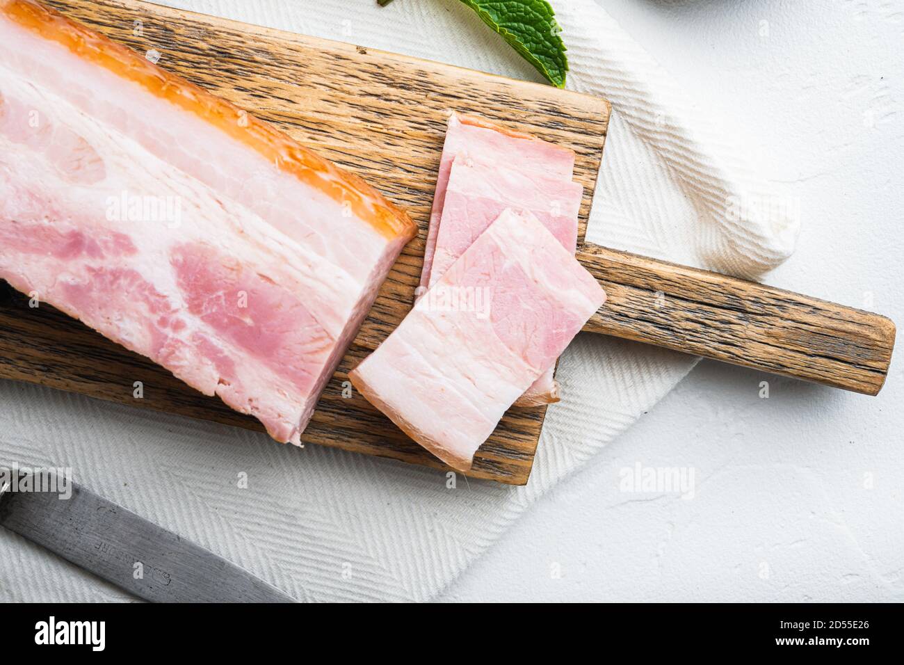 Bacon pancetta cut and sliced on white background Stock Photo - Alamy