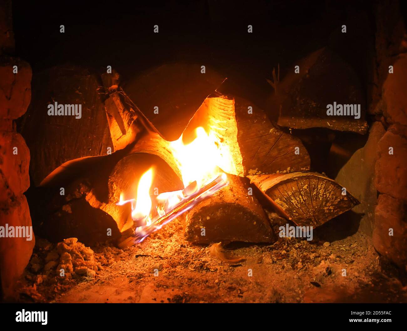 Warm light of a burning bright fire in a fireplace in old Russian stove ...