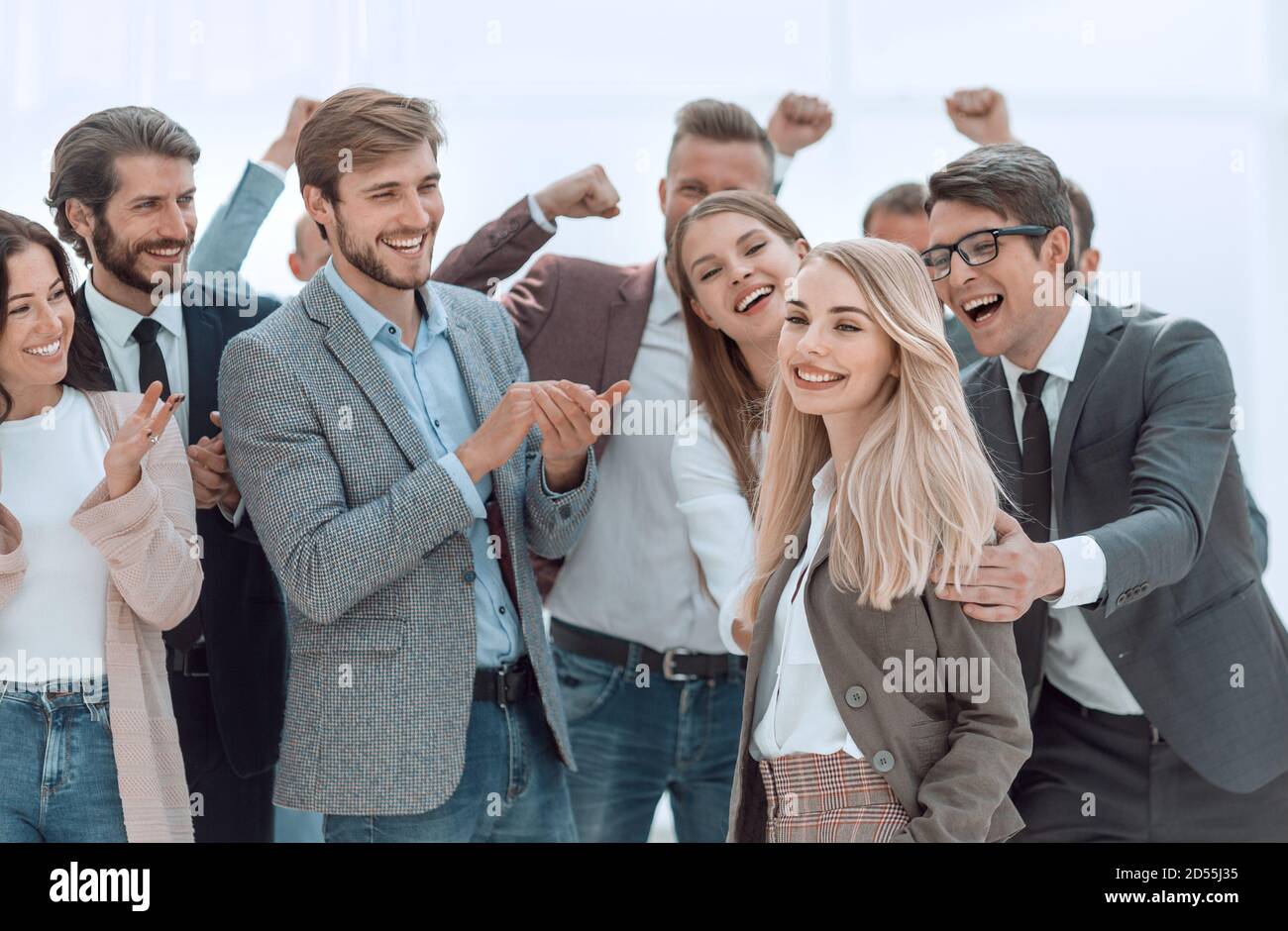 corporate group of employees applauding a young colleague Stock Photo ...