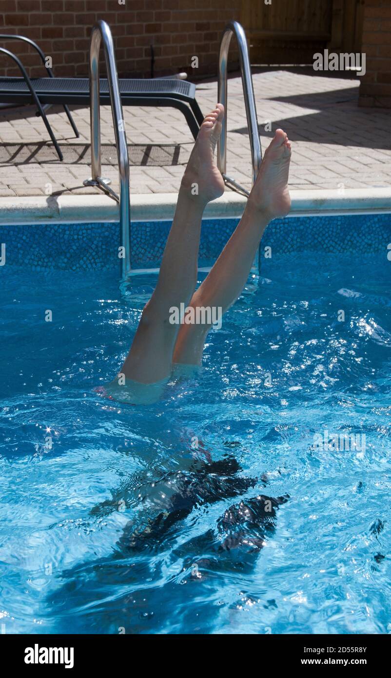 Handstand in swimming pool legs hi-res stock photography and images - Alamy