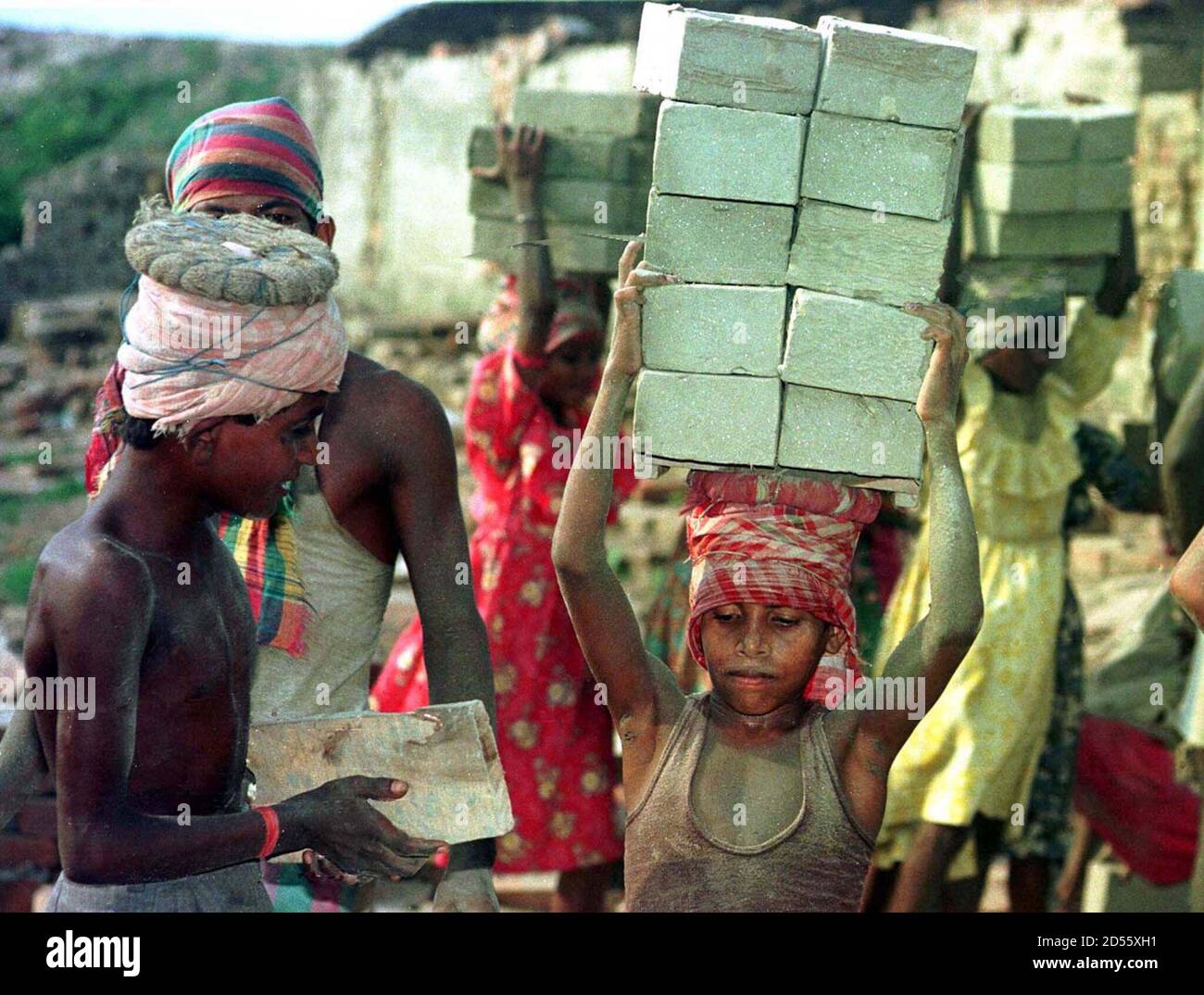 Children working child labour carrying hi-res stock photography and ...