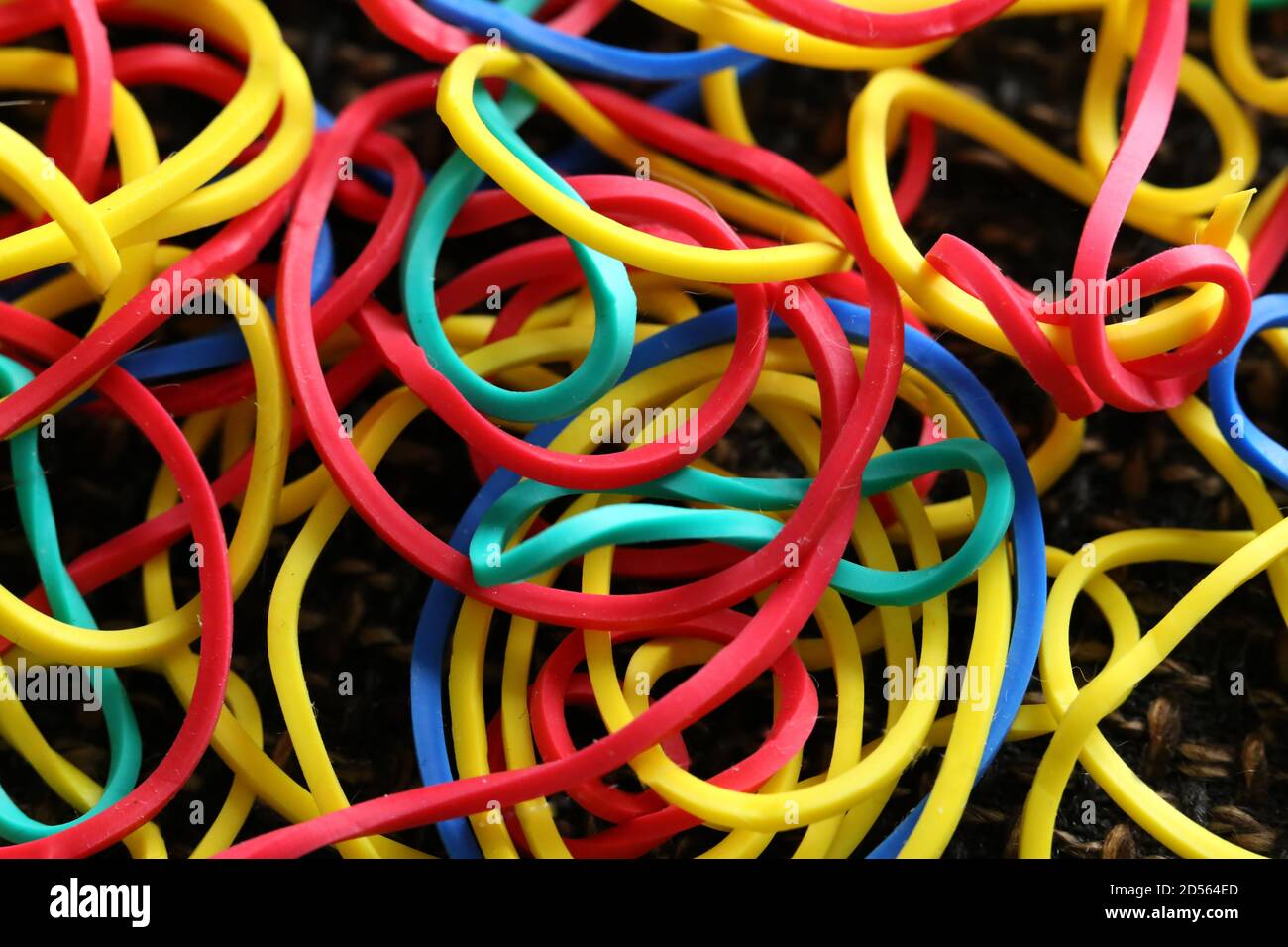 Multi-colored elastic stationery band rubber scattered on the table ...