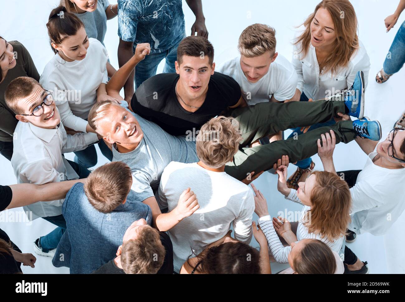 close up. a happy leader on the hands of his team Stock Photo - Alamy