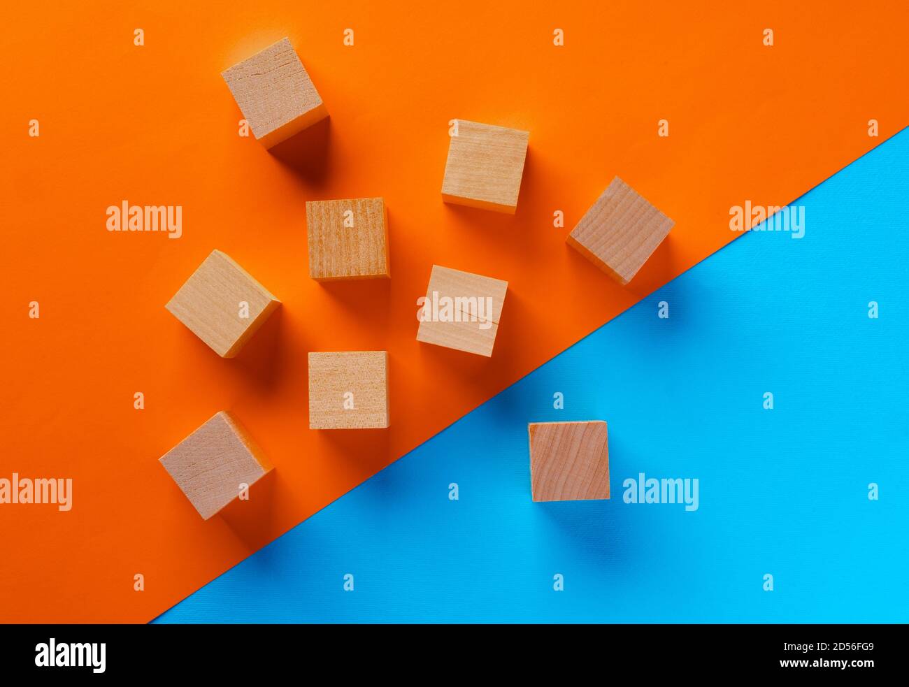 Wooden square blocks on orange and blue background Stock Photo - Alamy