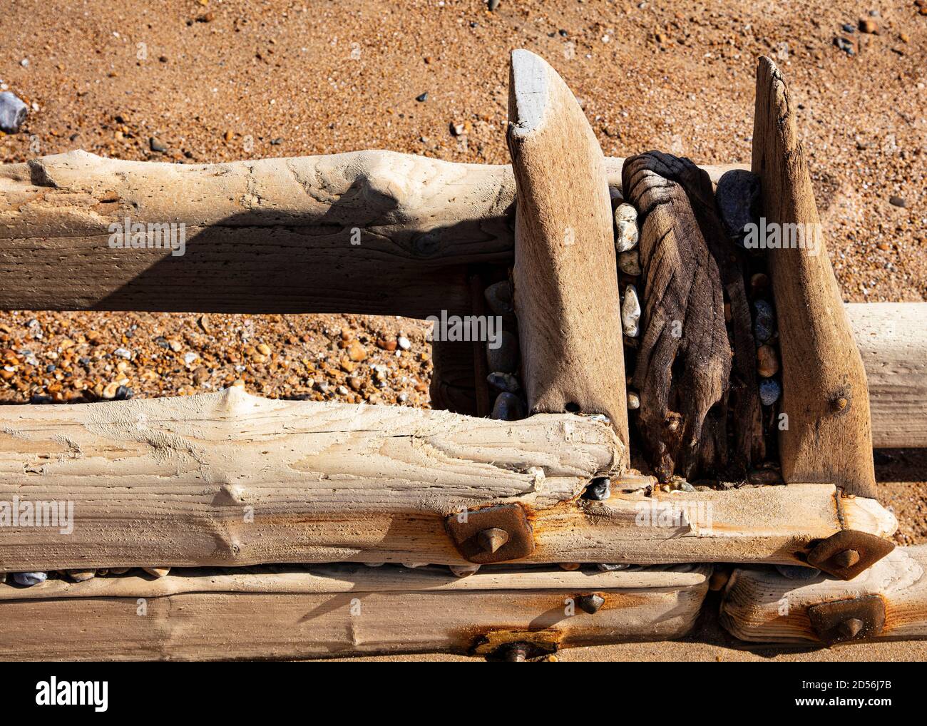 Weathered wooden sea defences on the beach at Bexhill, East Sussex ...