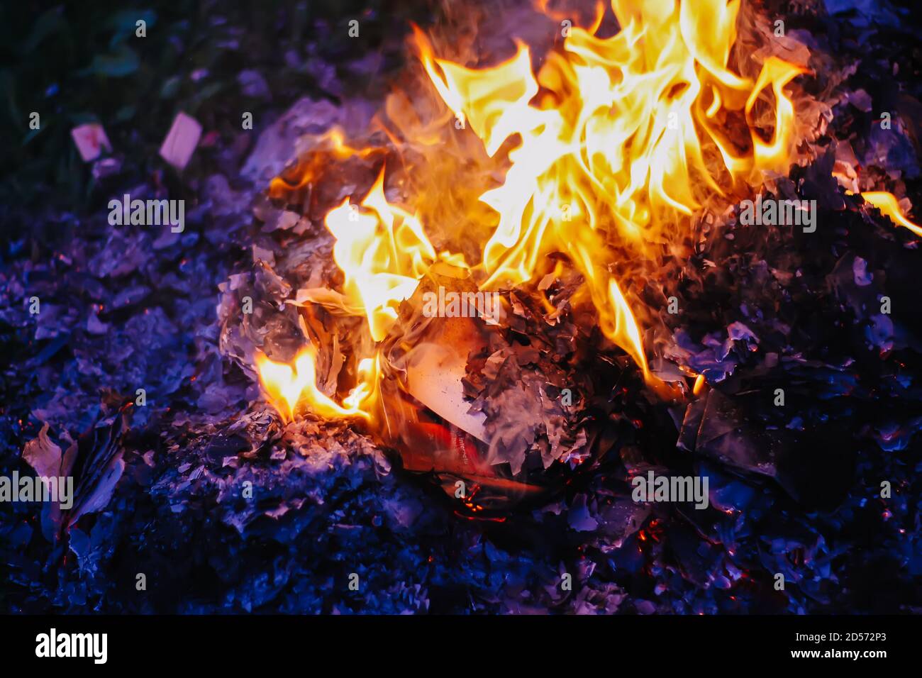 Paper burning on green summer grass outdoors Stock Photo - Alamy