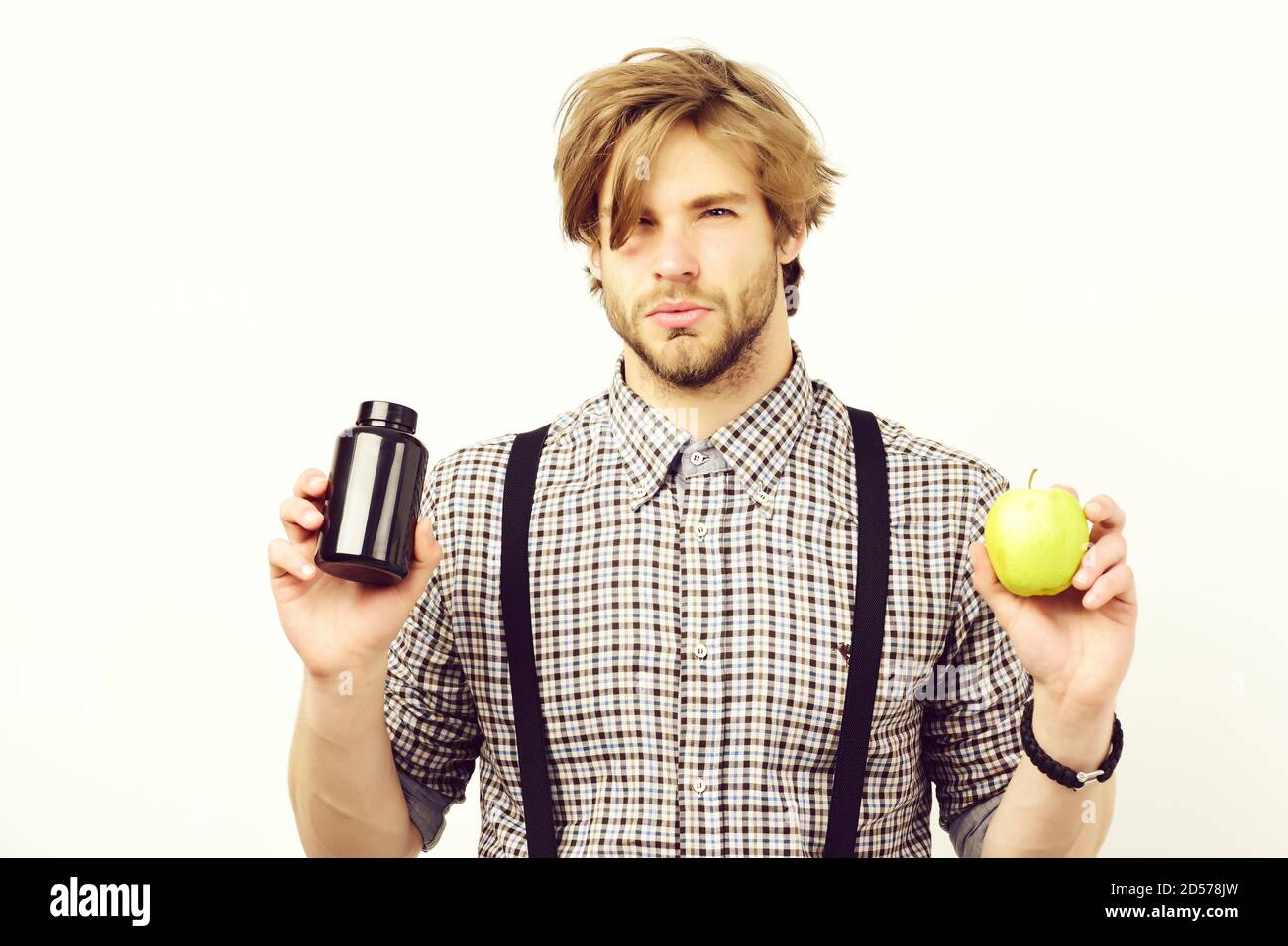 Macho with fresh fruit and bottle of pills, isolated on white ...