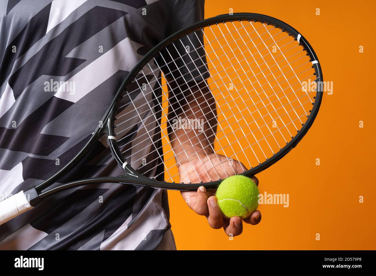 Close up shot of a tennis player hand with racket and ball against ...