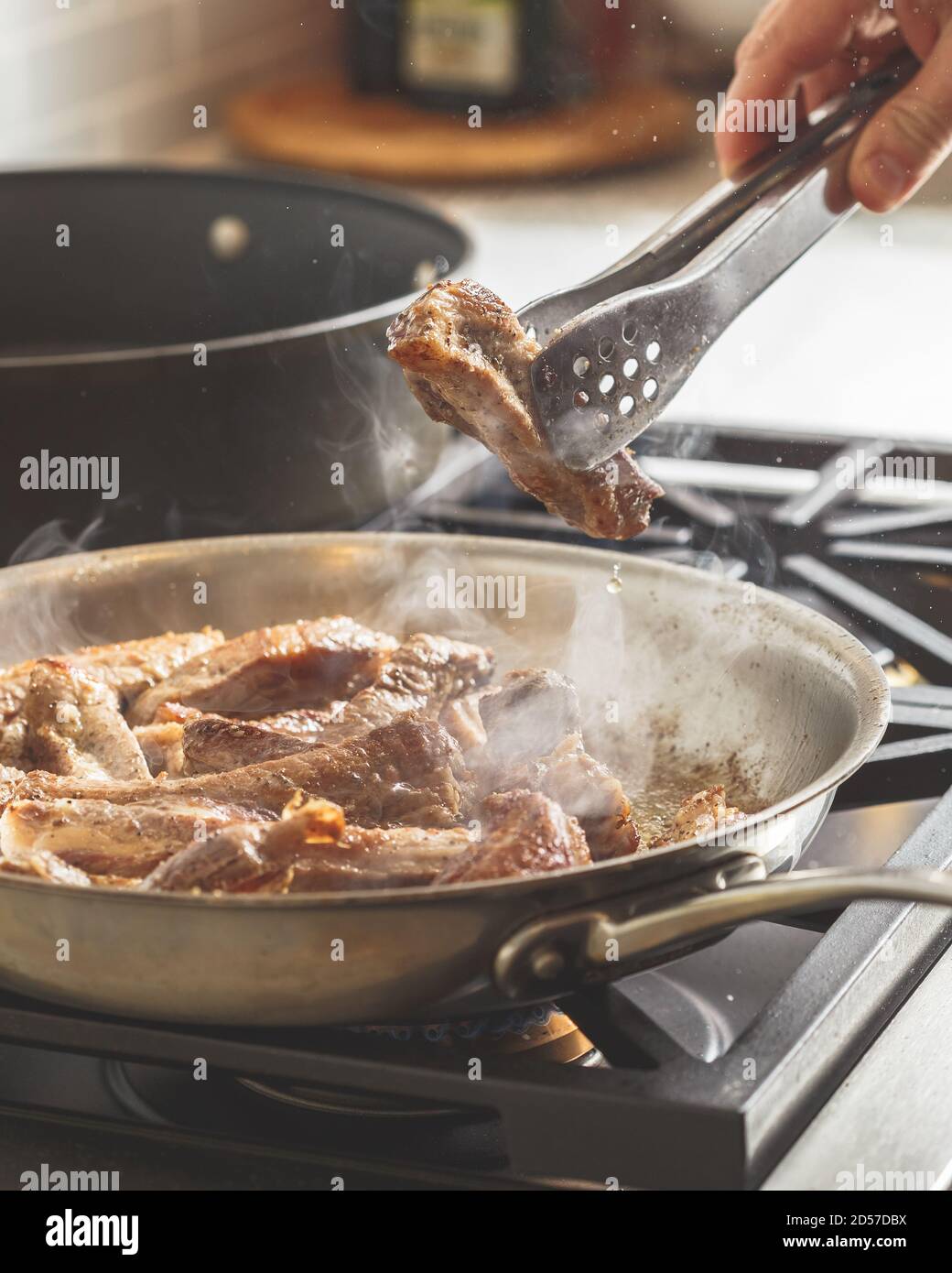 Baby back ribs meat being prepared on a steel pan. Cooking at home ...